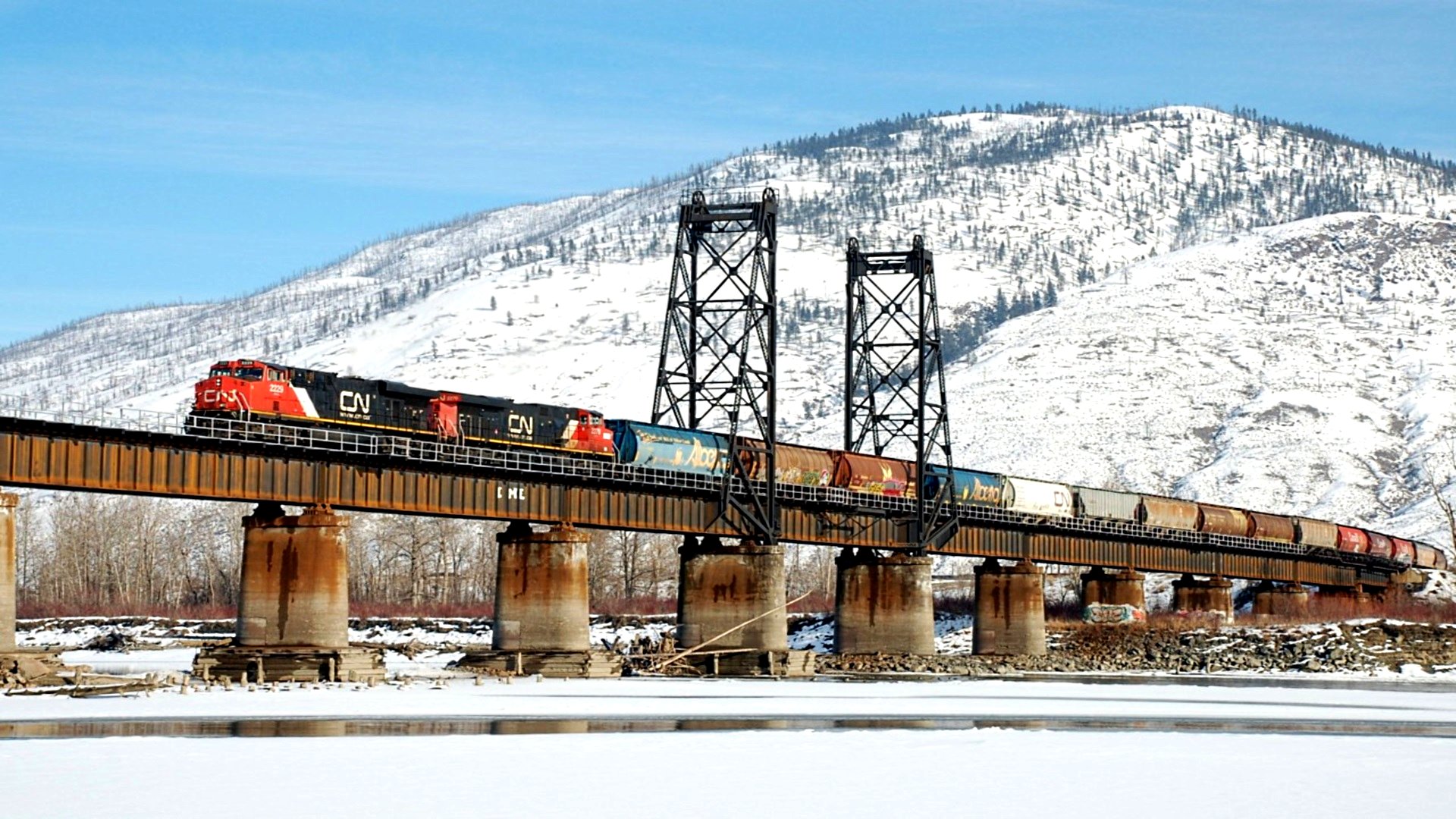 HD Wallpaper of a Train Crossing a Snowy Landscape