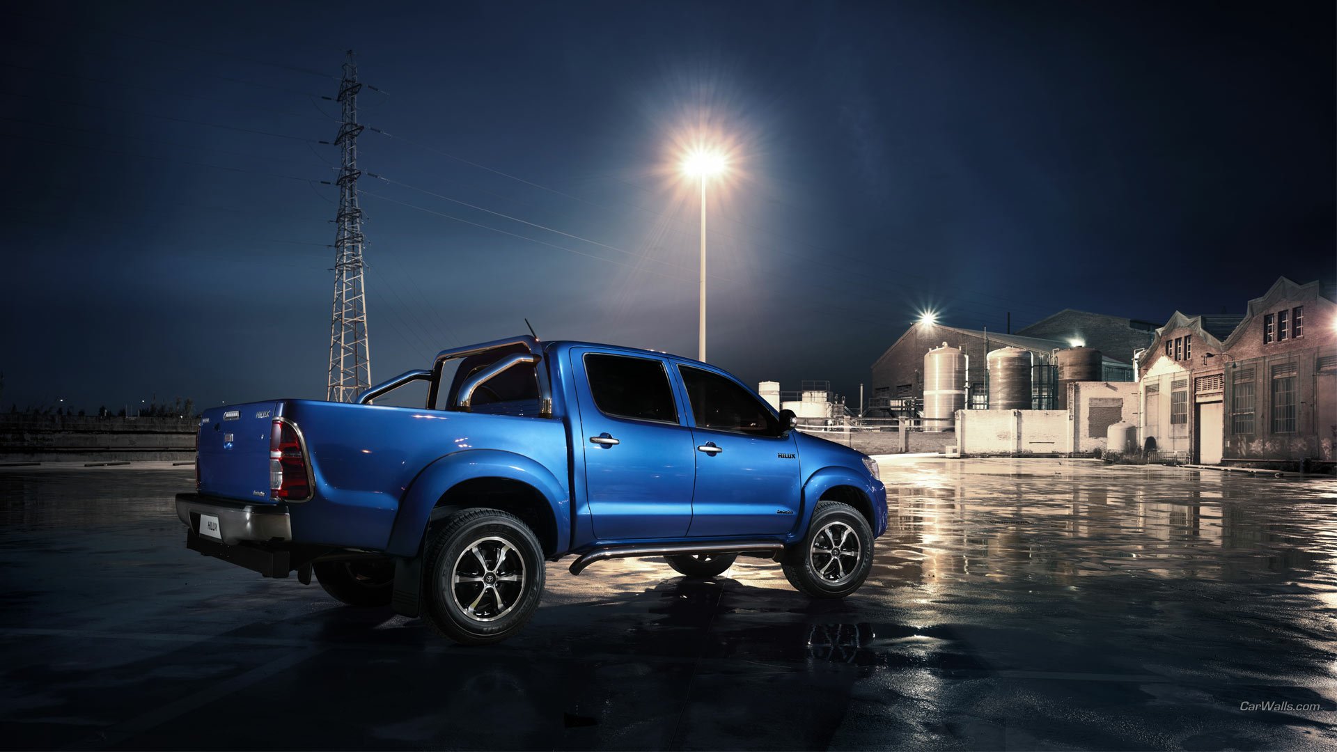 Toyota Hilux HD Wallpaper: Rugged Power Meets Nighttime Cityscape