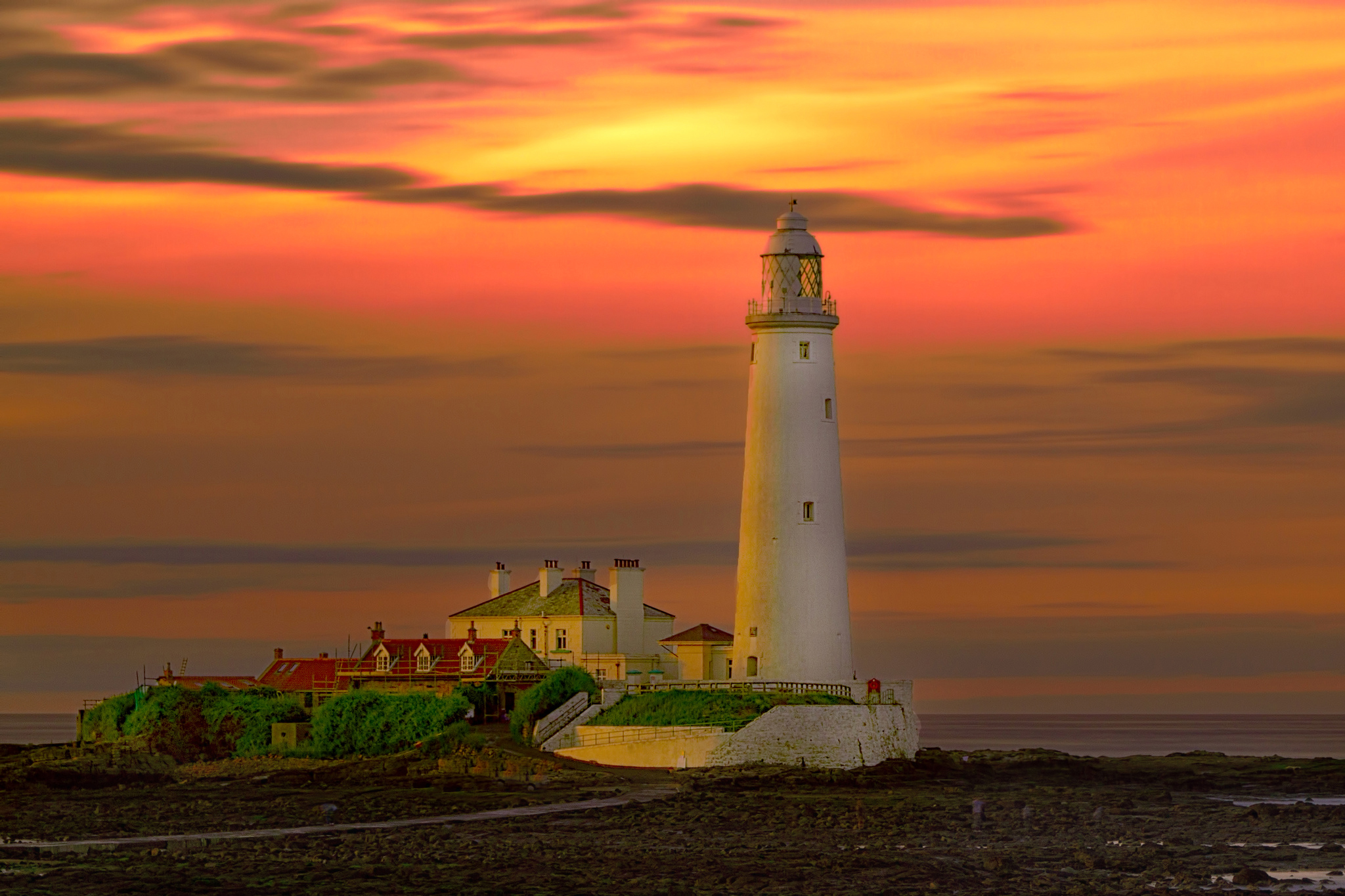 Golden Horizon Lighthouse at Sunset – Vibrant Yellow-Orange Sky HD Wallpaper