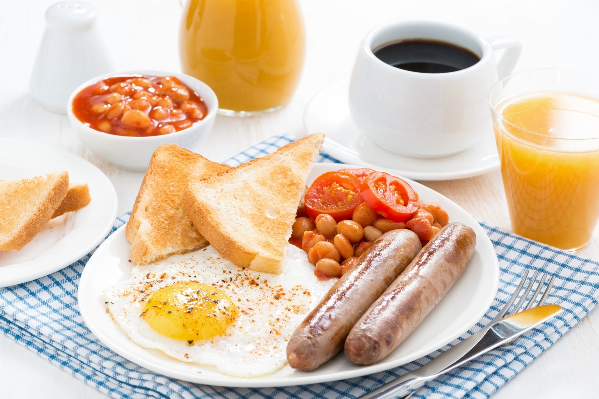 Hearty Breakfast Feast: Juices, Coffee, Sausage, Eggs, Toast & Jam Delight