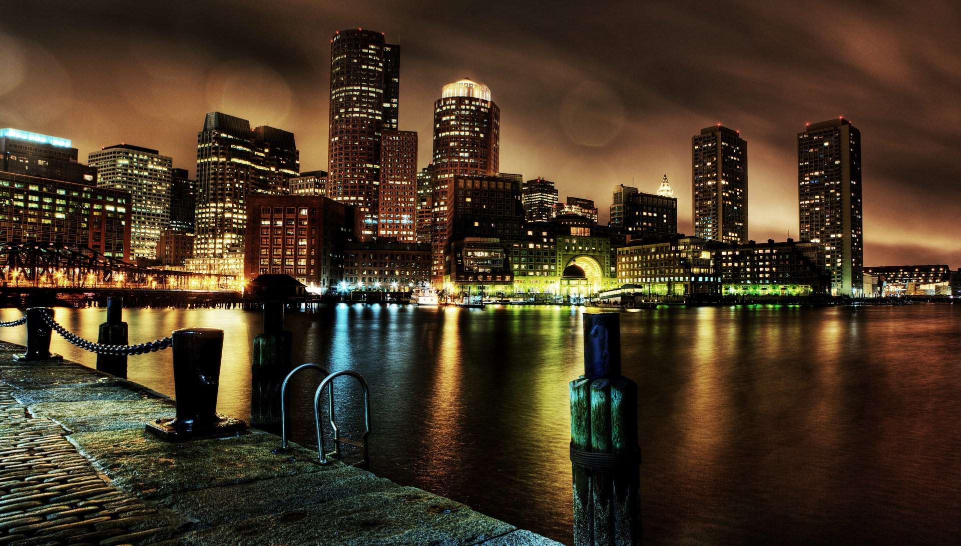 Boston Skyline at Night: Illuminated Skyscrapers Reflecting on the Harbor