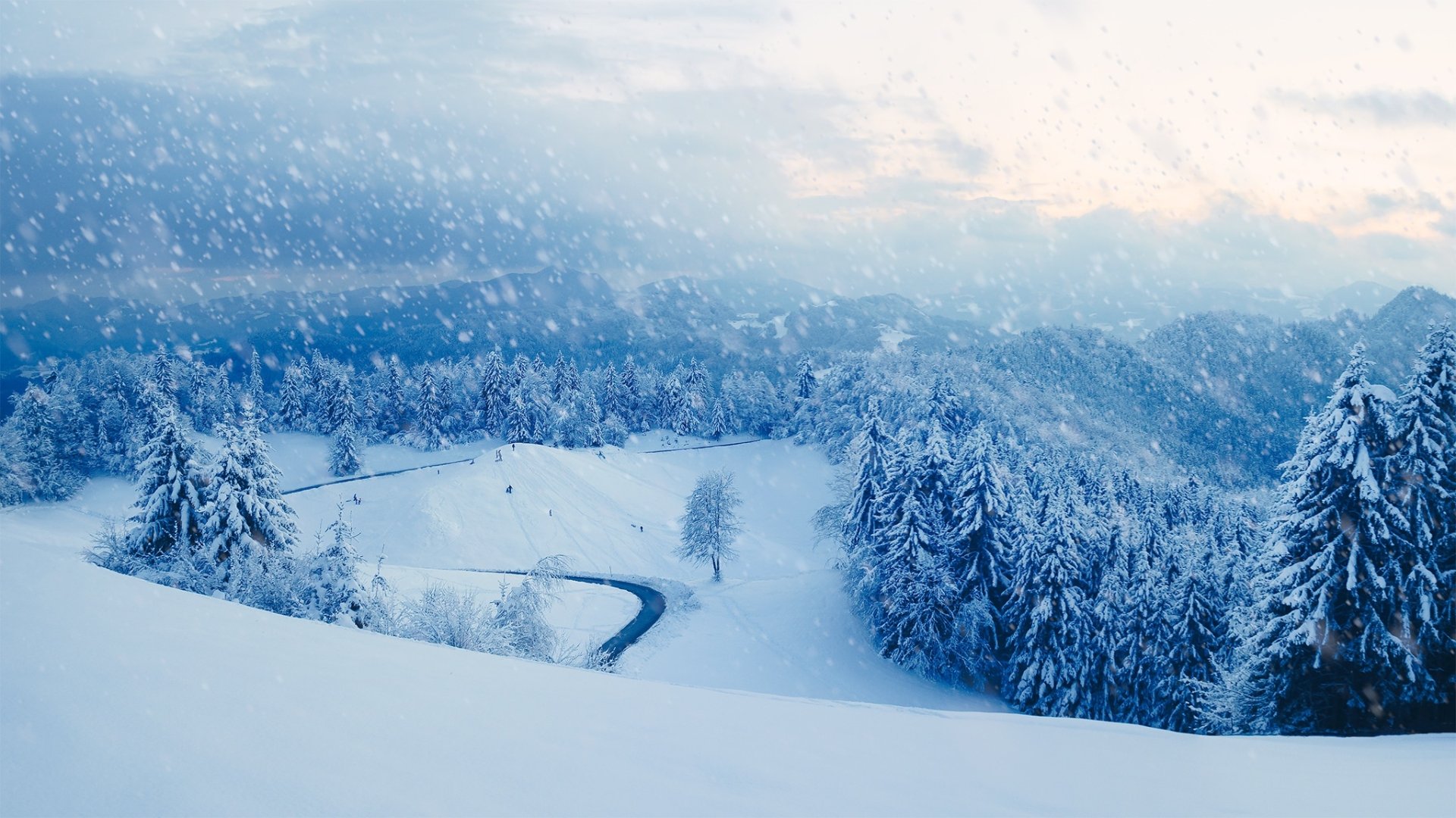 Winter Wonderland: Snowfall Over Serene Forest Landscape – HD Wallpaper