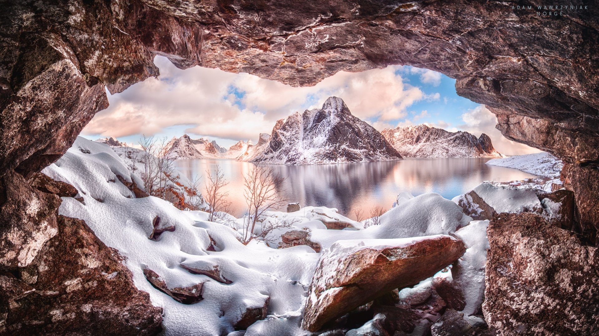 Winter Serenity: Snow-Covered Cave Overlooking Tranquil Lake HD Wallpaper